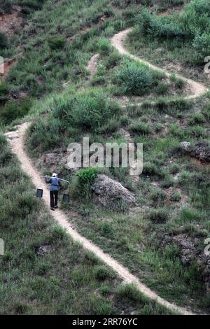 FILE - Villagers fetch water from a makeshift borehole in Mudzi ...