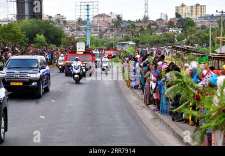 210320 -- DAR ES SALAAM, March 20, 2021 -- People line the street as a ...
