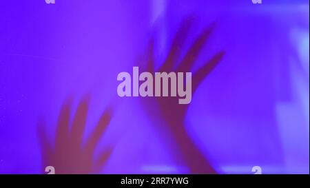 Defocused abstact silhouette of arm, hand spooky action, alien, ghost ...