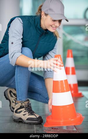 Male instructor with traffic cone and student on road, lesson in ...