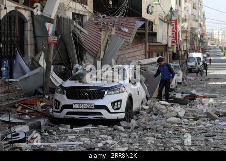 210513 -- GAZA, May 13, 2021 -- Palestinians inspect the rubble of a ...