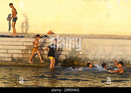 210625 -- ASWAN EGYPT, June 25, 2021 -- A child cools himself in the ...