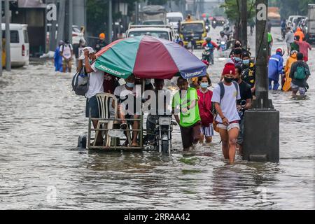 210724 -- RIZAL PROVINCE, July 24, 2021 -- People wade through the ...