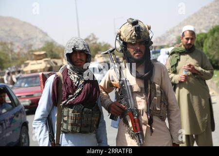 Taliban fighters stand guard in front of the former U.S. embassy the ...