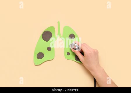 Paper lungs with tumors and stethoscope on beige background. Lung ...