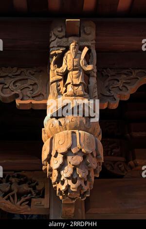 carved figures in front of the door Stock Photo - Alamy
