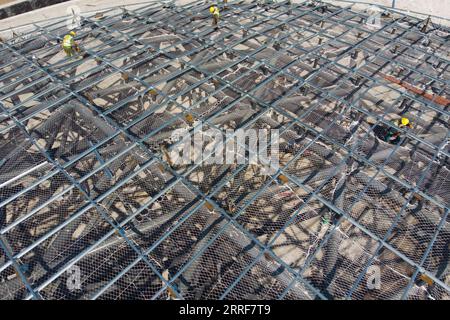 Aerial photo shows workers are busy cutting and mining ice on the ...