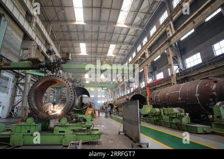 220416 -- HARBIN, April 16, 2022 -- Workers work at a factory of Harbin ...