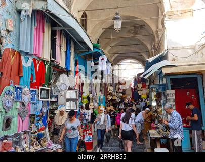 Tunis, Tunisia - 27 August, 2022: People walking in the medina quarter ...