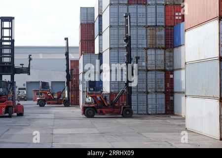 Container stacker loading freight containers Stock Photo - Alamy