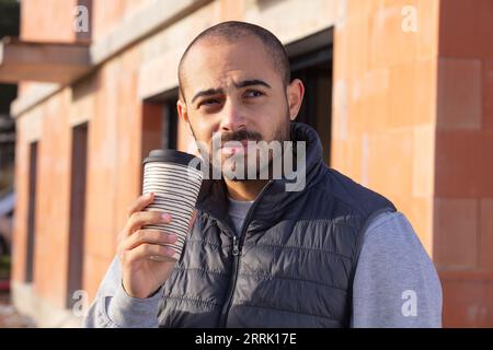 builder taking a welcome coffee break Stock Photo - Alamy