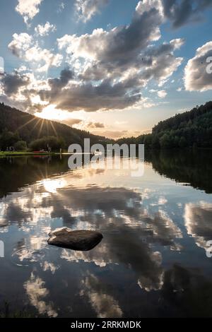 A beautiful shot of a sunset over a lake and mountains Stock Photo - Alamy