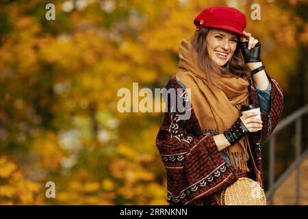 Hello september. Portrait of happy young female in sweater with leather ...