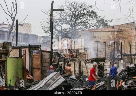 230219 -- QUEZON CITY, Feb. 19, 2023 -- Residents are seen on the ...