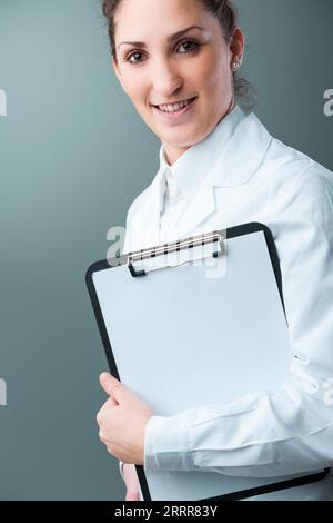 study, a woman, and a reassuring smile. Her tablet symbolizes readiness ...
