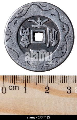 Ancient Chinese silver coin with a square hole 1. Reverse. Isolated on ...