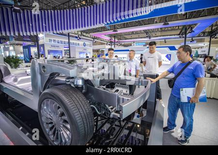 230904 -- CHONGQING, Sept. 4, 2023 -- Visitors look at the model of a ...