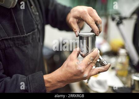 Paint spray gun in the hands of a painter close up Stock Photo - Alamy