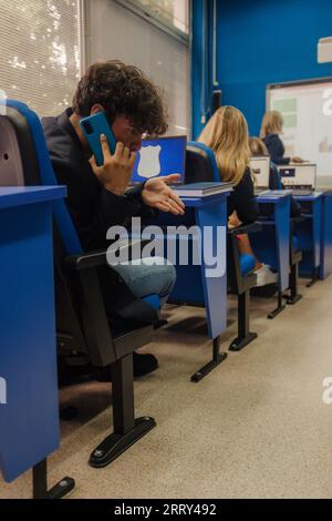 College students attending classes. Male student going on a break ...