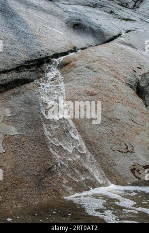 Temporary waterfalls form on the granite domes surrounding Tenaya Lake ...
