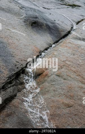 Temporary waterfalls form on the granite domes surrounding Tenaya Lake ...