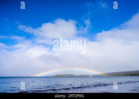 rainbow over the ovean and above an island in australia Stock Photo - Alamy