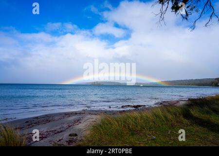 rainbow over the ovean and above an island in australia Stock Photo - Alamy