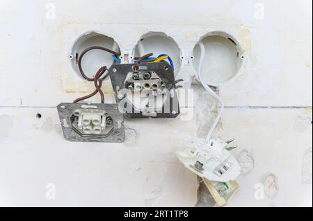 Open euro electrical socket on a grungy gray wall. Close-up. Electrical ...