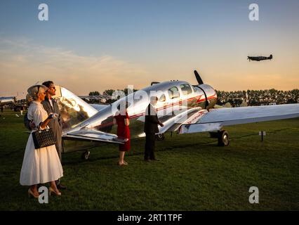 A Spitfire flies as the sun sets during the Goodwood Revival at the ...