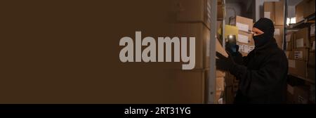 Warehouse thief stealing boxes of goods at night. the concept of ...