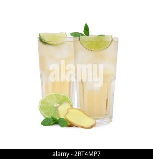 Glasses of tasty ginger ale with ice cubes and ingredients isolated on ...