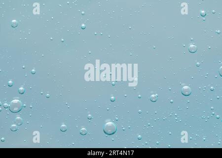 Transparent cleansing gel on dusty light blue background, top view ...