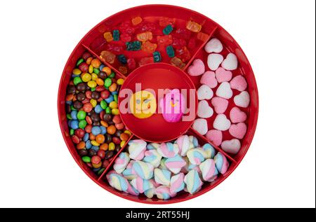 Set of different tasty candies in a red candy box on red background ...