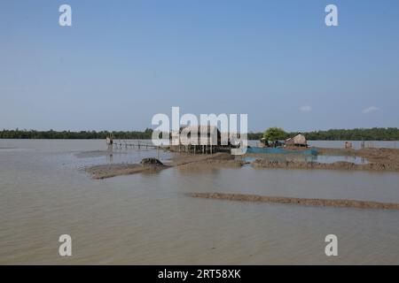 Houses are seen at the edge of the Sundarbans coastal area in Sathkhira ...