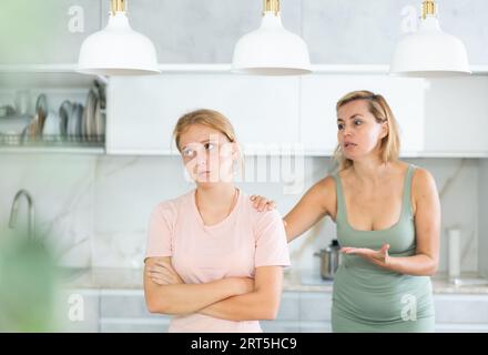 Angry mother yells at teenage girl sad daughter Stock Photo - Alamy