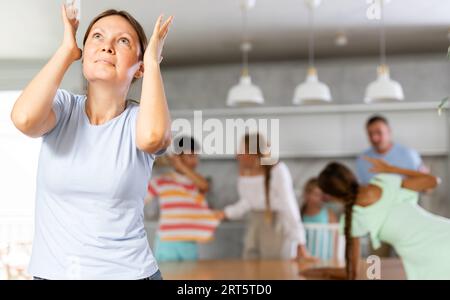 Irritated mom is tired of noise and screams of the children at home ...