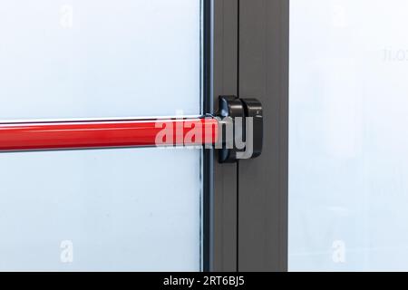 Red panic bar. Mandatory safety handle in public places Stock Photo - Alamy