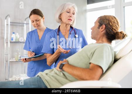 Sick male patient having aching belly and visiting doctor Stock Photo ...