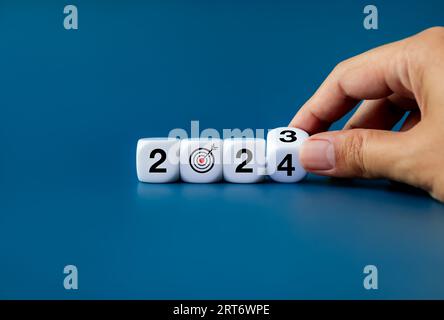 Hand flipping the year cube 2024 to 2025 Stock Photo - Alamy