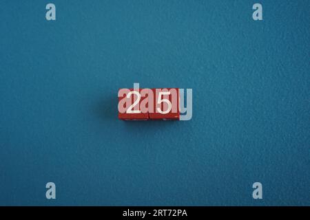 Wooden Viva Magenta cubes with number 7 on blue background close-up top ...