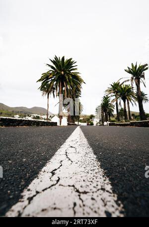 wide angle shot of empty road with grain silo in distance on Route 66 ...