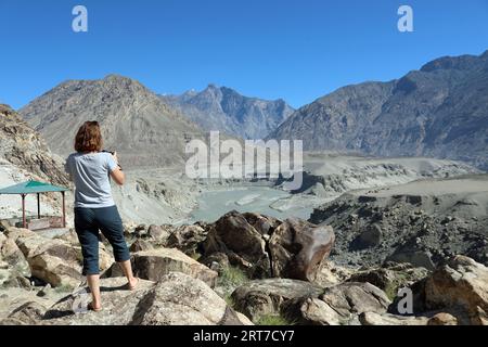 Tourist at the viewpoint for three mountain ranges in northern Pakistan ...