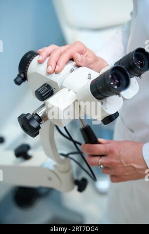 Female gynecologist uses a gynecological microscope in her work Stock ...