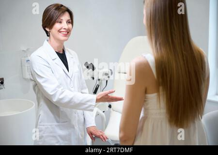 doctor gynecologist offers female patient to use IUD to prevent ...