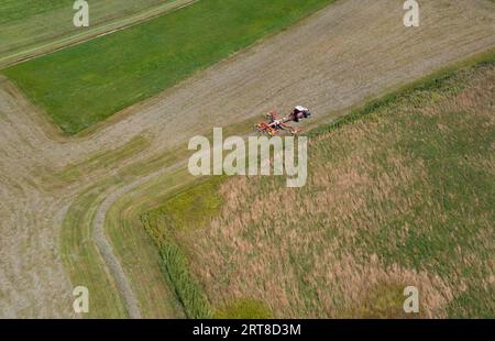 Drone view photo of a tractor in a vineyard field with people working ...
