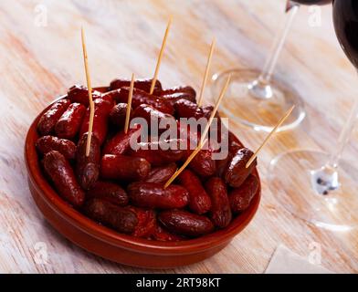 Grilled mini sausages chistorra Stock Photo - Alamy