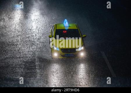 CHONGQING, CHINA - SEPTEMBER 11, 2023 - People walk through the rain in ...