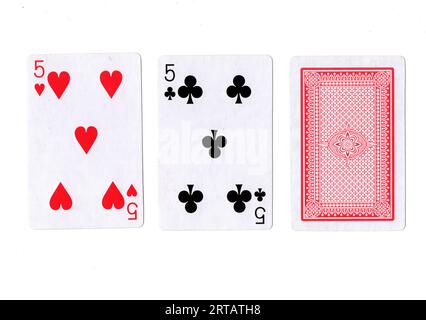 A hand of three playing cards revealing two nines on a white background ...