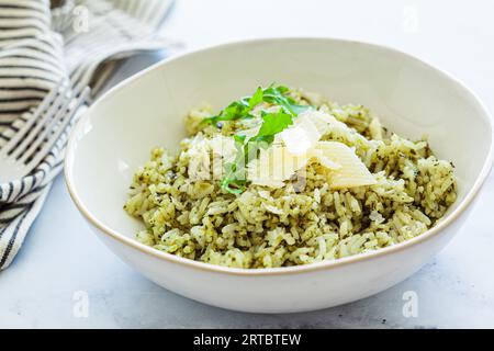 Green pesto risotto with parmisan, white marble background, close-up ...
