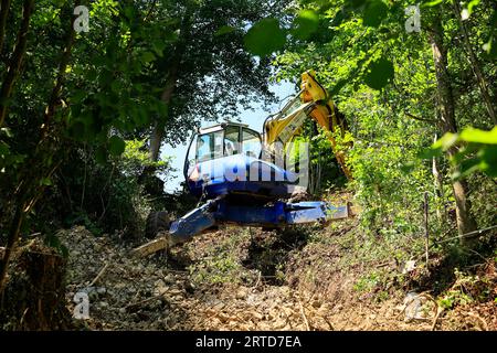 Excavator stands on a steep slope Stock Photo - Alamy